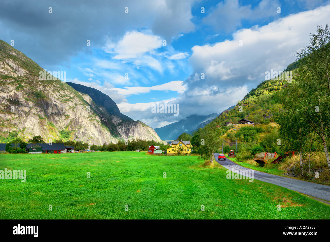 Picturesque view of green valley in mountains and forest with farm ...