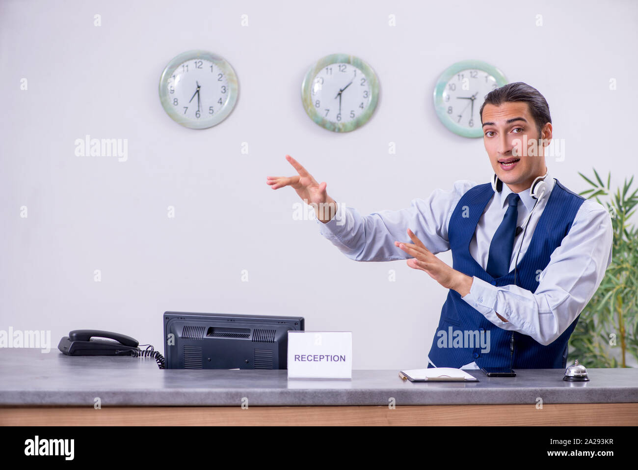 The young man receptionist at the hotel counter Stock Photo - Alamy