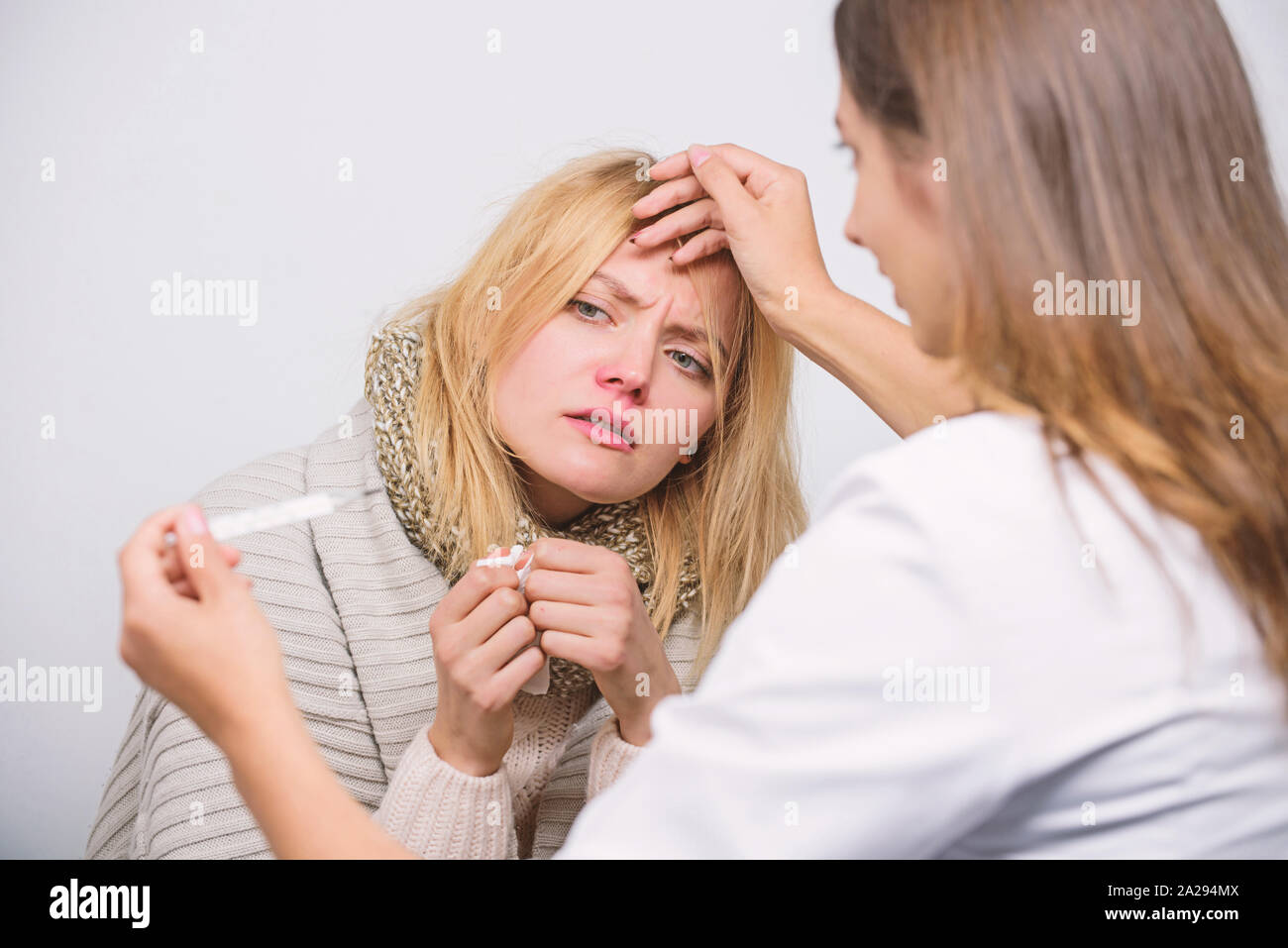 Her fever makes her uncomfortable. Doctor visiting unhealthy woman at ...
