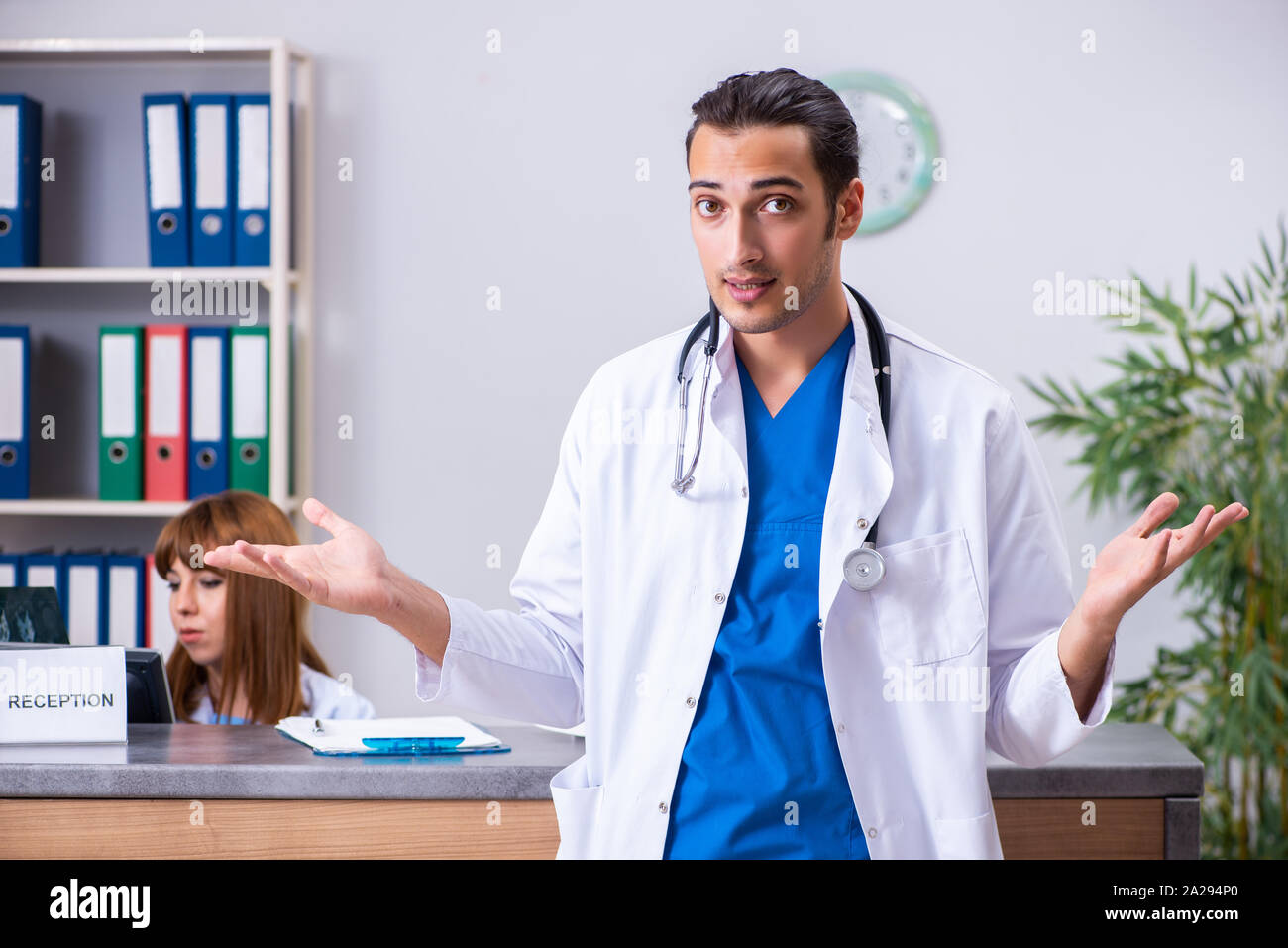 The two doctors working at the reception in the hospital Stock Photo ...
