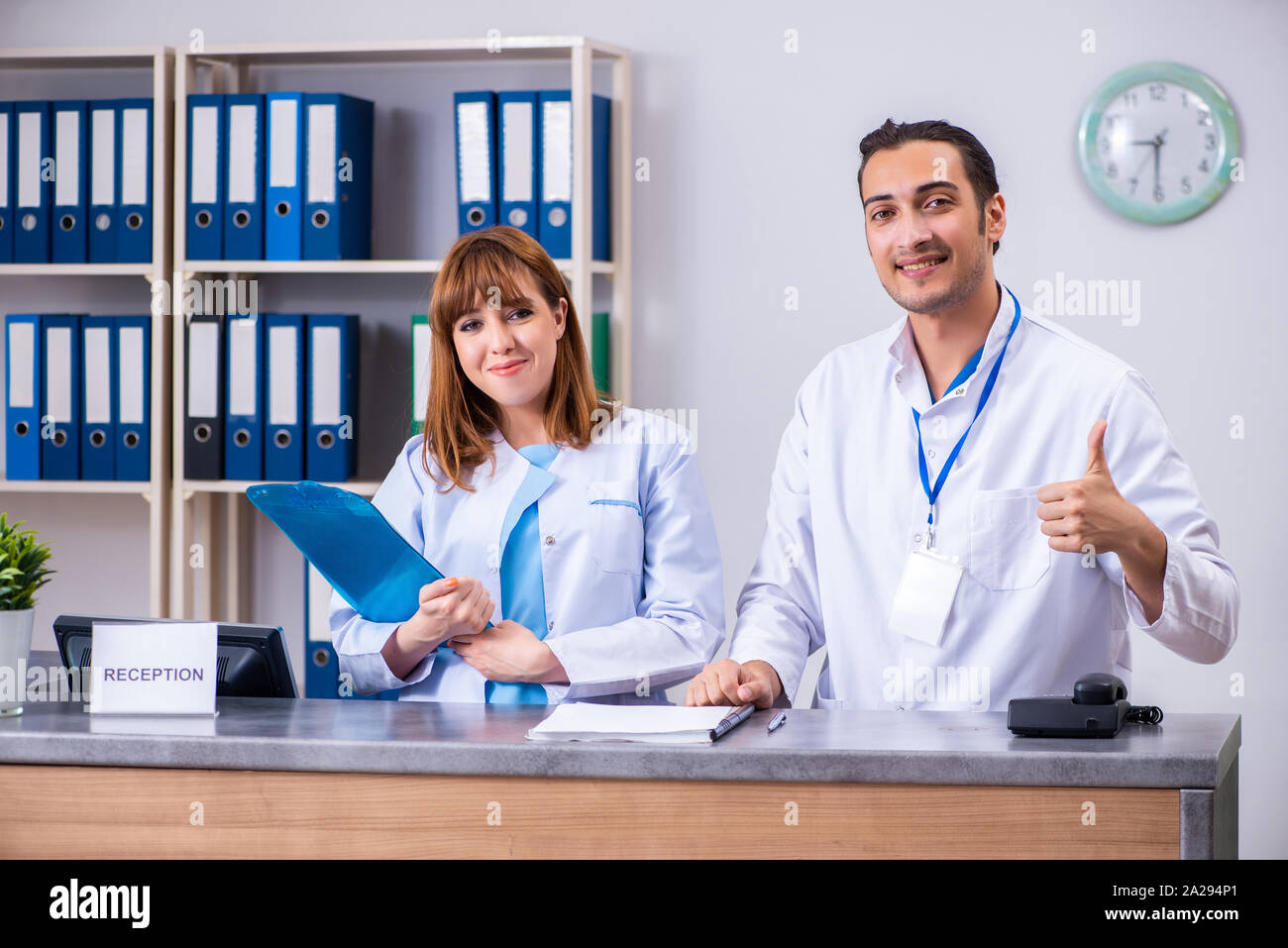 The two doctors working at the reception in the hospital Stock Photo ...