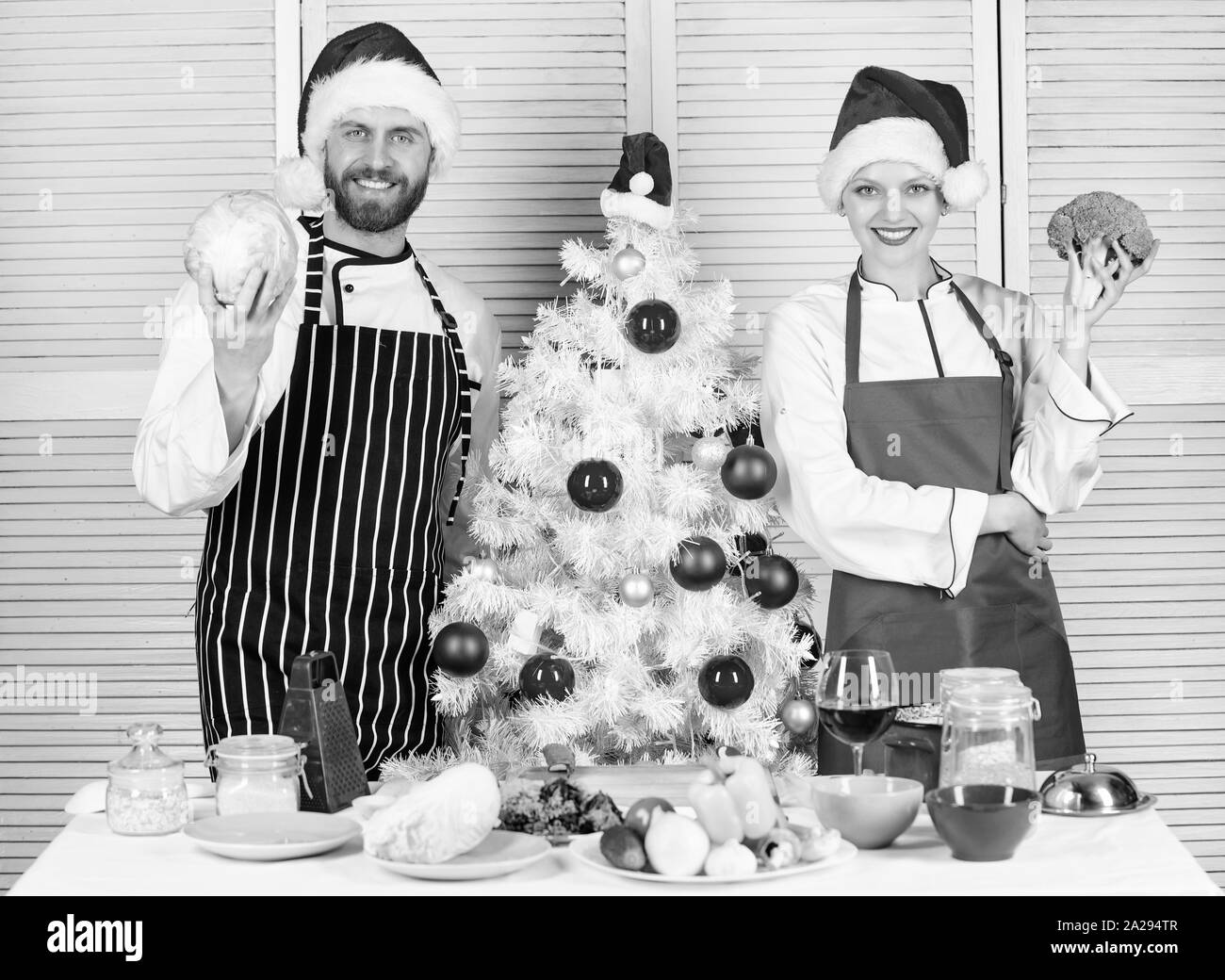 Man and woman chef apron santa hat near christmas tree. Christmas ...