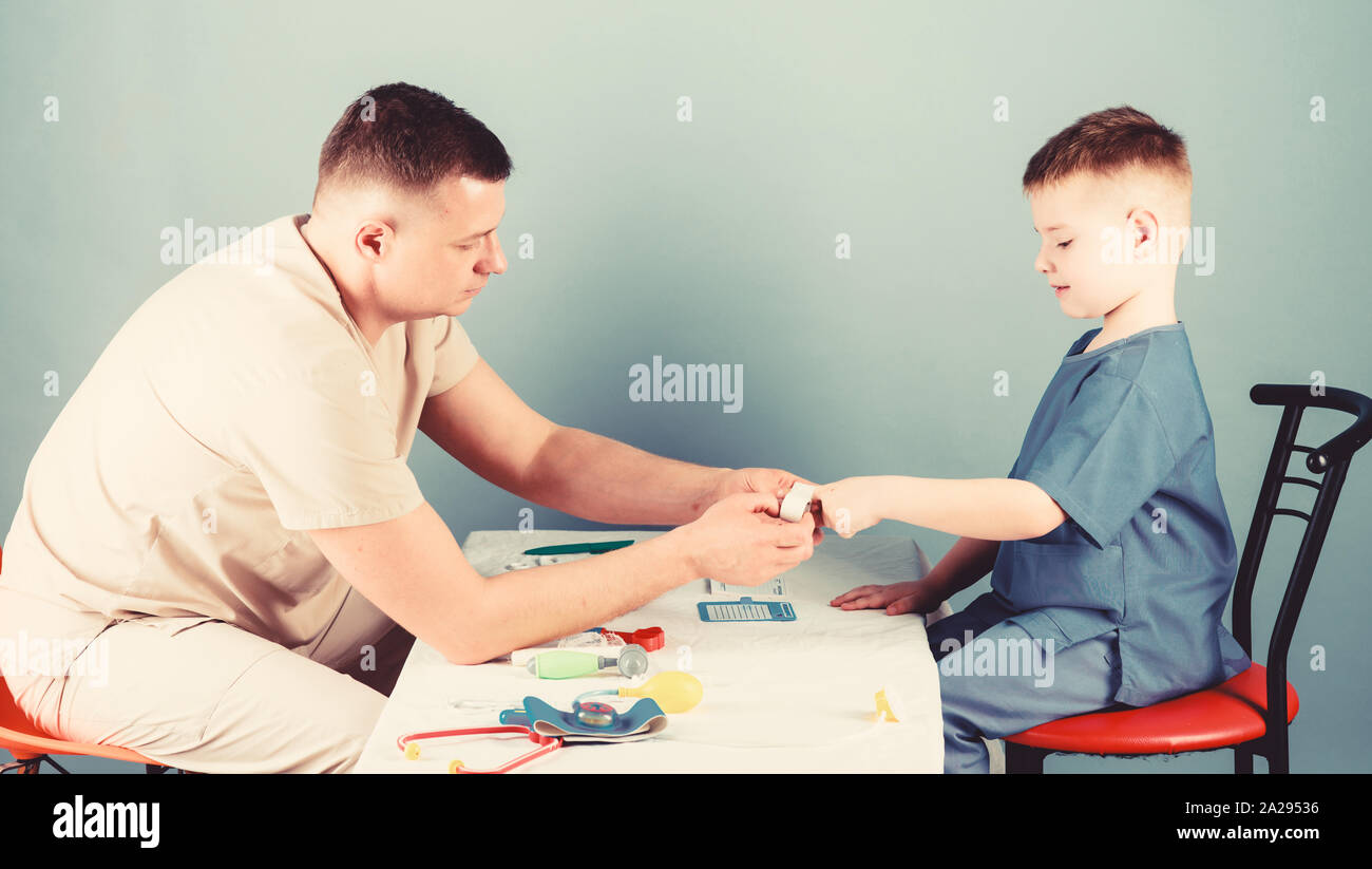 medicine and health. small boy with dad play. pediatrician intern ...