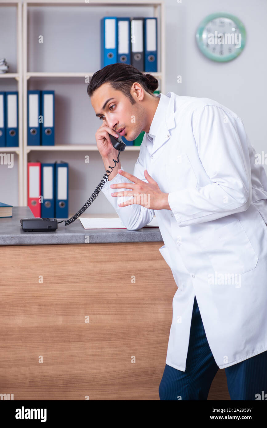 The young male doctor at the reception in the hospital Stock Photo - Alamy