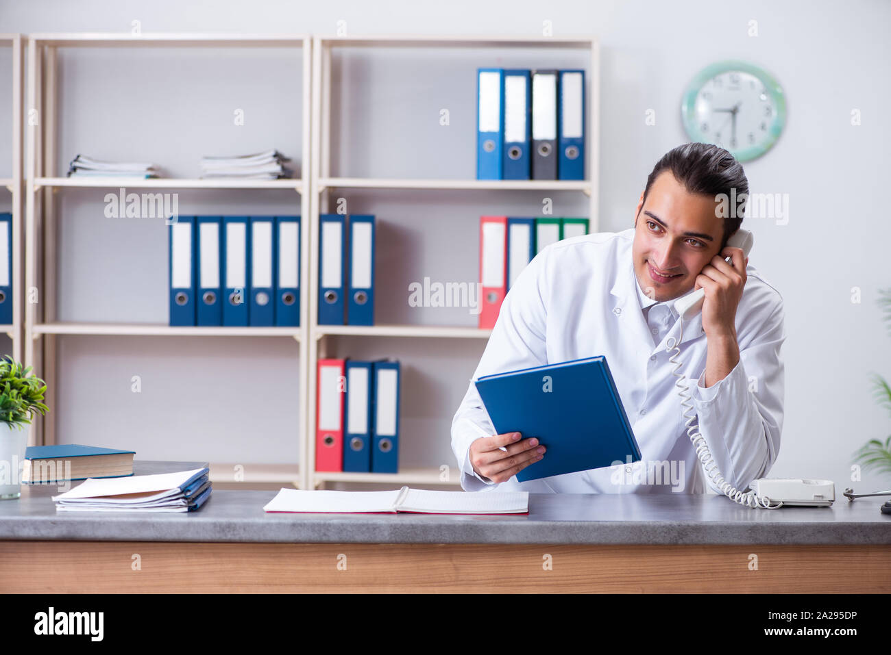 The young male doctor at the reception in the hospital Stock Photo - Alamy