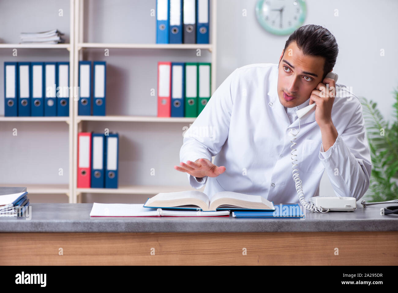 The young male doctor at the reception in the hospital Stock Photo - Alamy