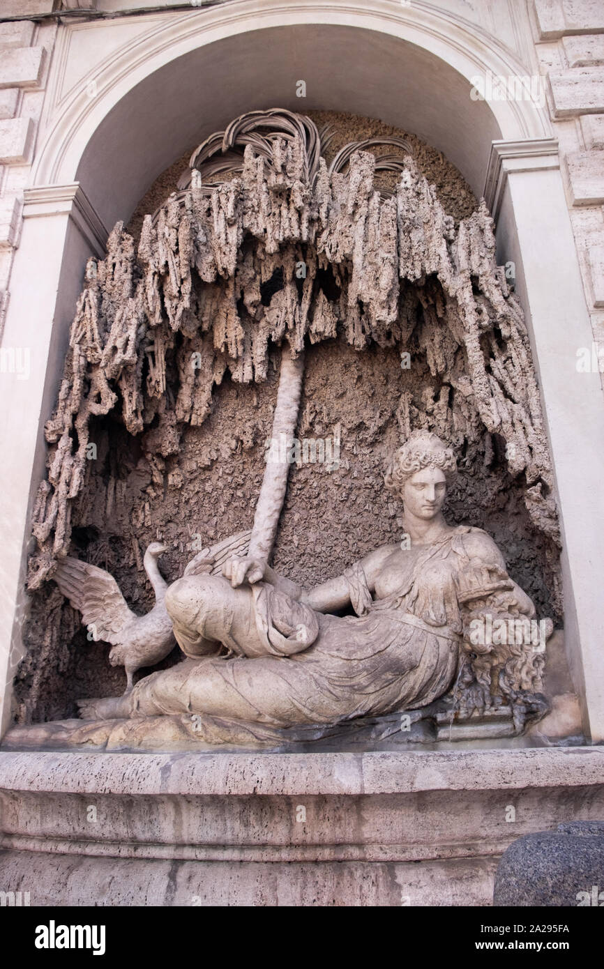 marble carved sculpture of a lady reclining against a backdrop of a ...