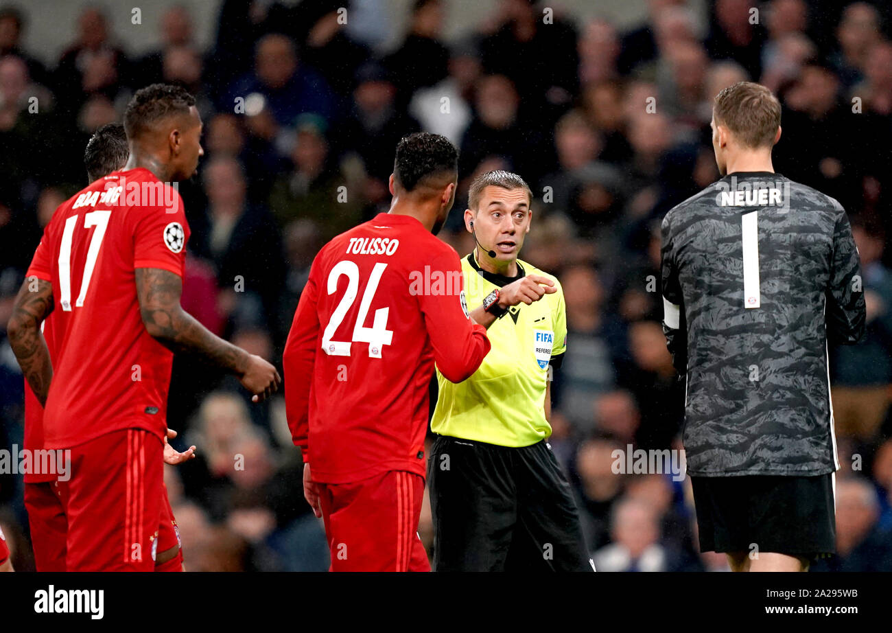 Referee Clement Turpin (centre) speaks to Bayern Munich players during ...