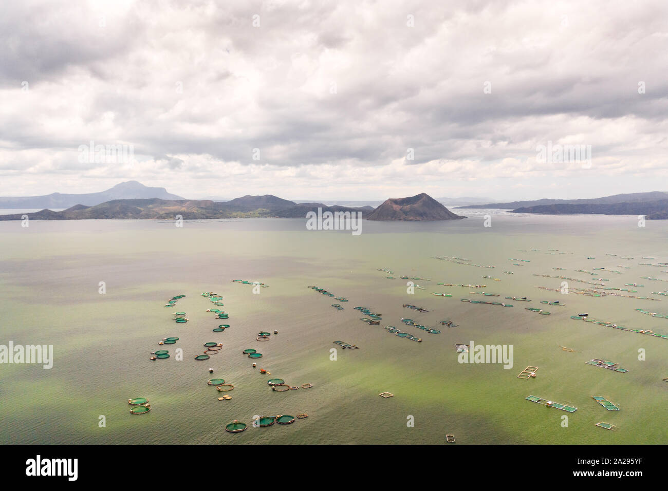 Lake Taal with a volcano and fish cages on a fish farm, top view. Luzon ...