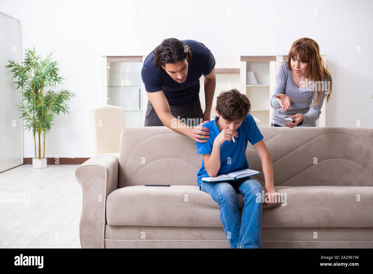 The concept of underage smoking with young boy and family Stock Photo ...