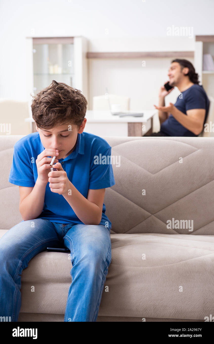 The concept of underage smoking with young boy and family Stock Photo ...