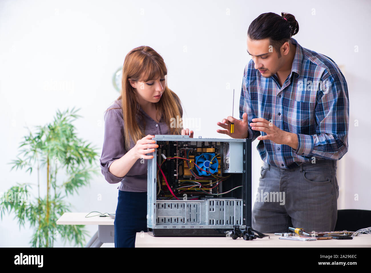 The two repairmen repairing desktop computer Stock Photo - Alamy