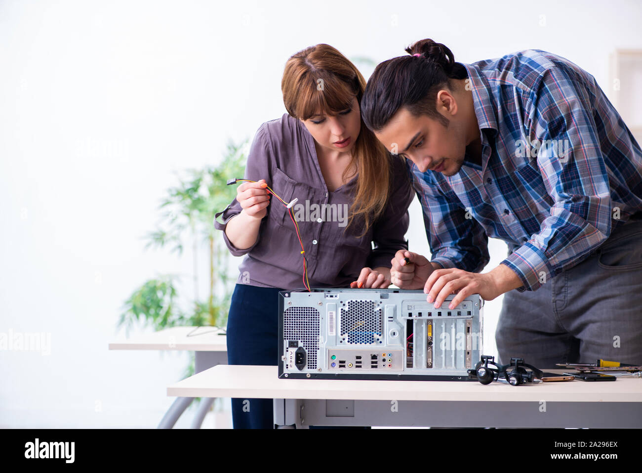 The two repairmen repairing desktop computer Stock Photo - Alamy