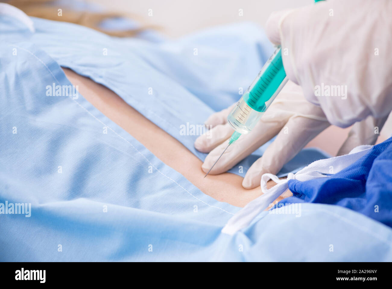 The female patient getting an injection in the clinic Stock Photo - Alamy