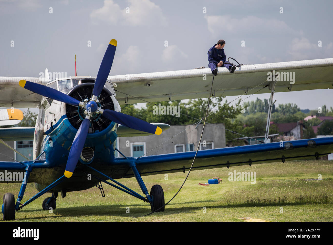 Repair man on top of plane wing, fueling at an european air show Stock ...