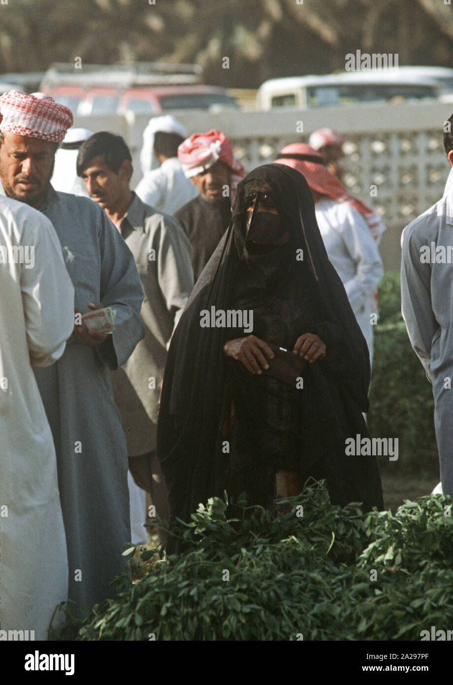 Woman wearing a traditional abaya, a long black robe with a hijab ...