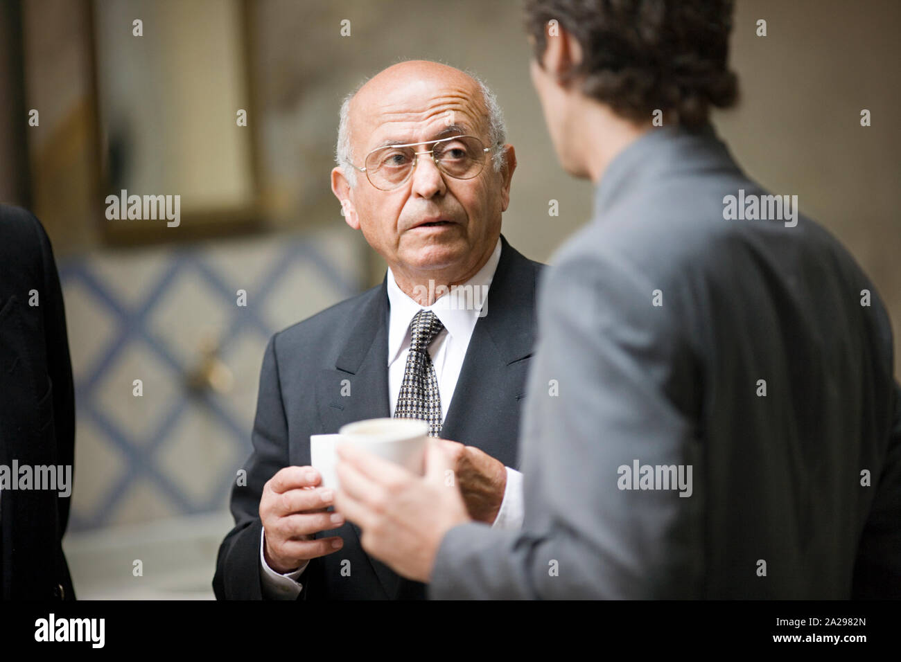 View of two men in animated conversation Stock Photo - Alamy