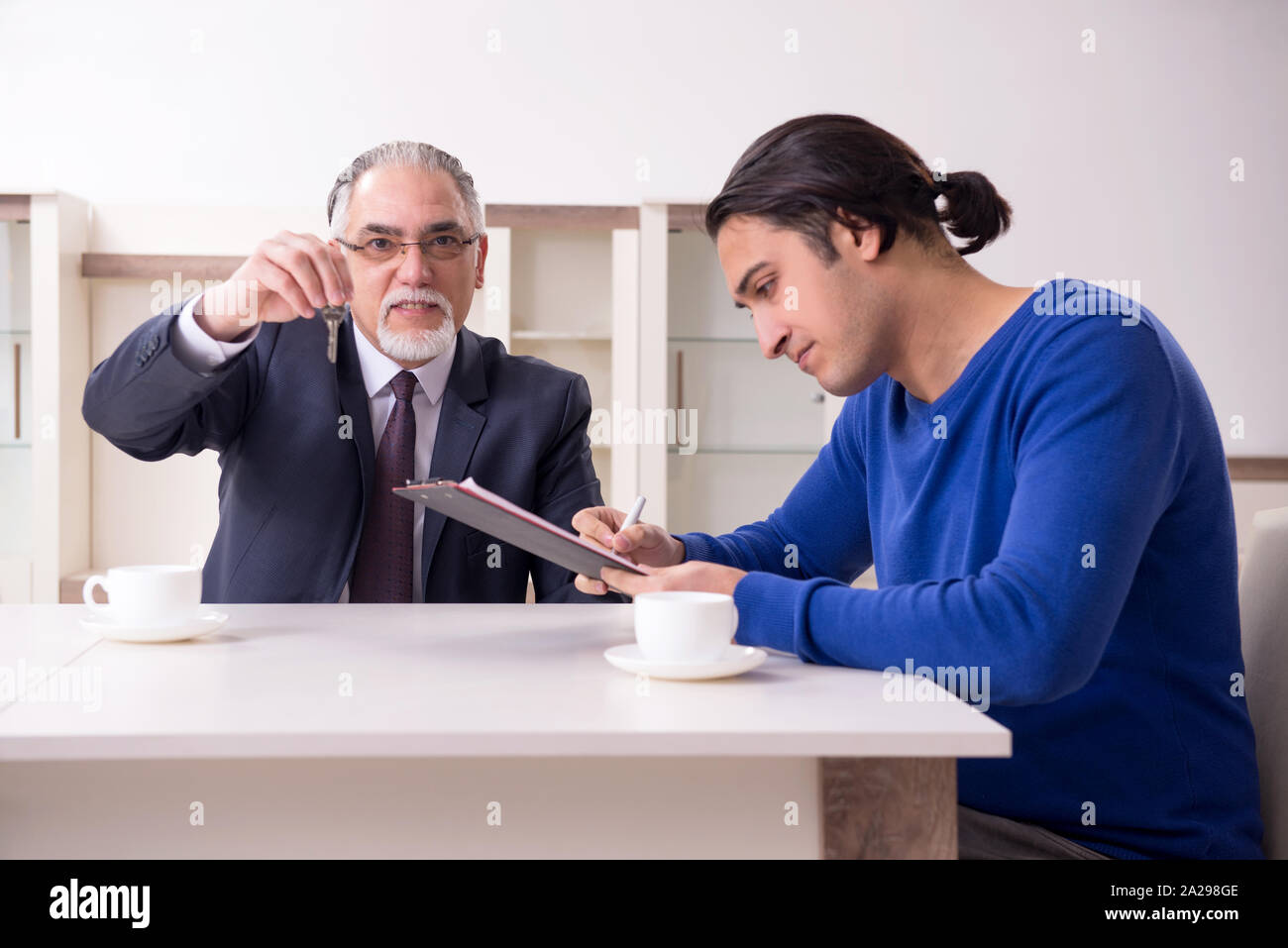 The male real estate agent and male client in the apartment Stock Photo ...