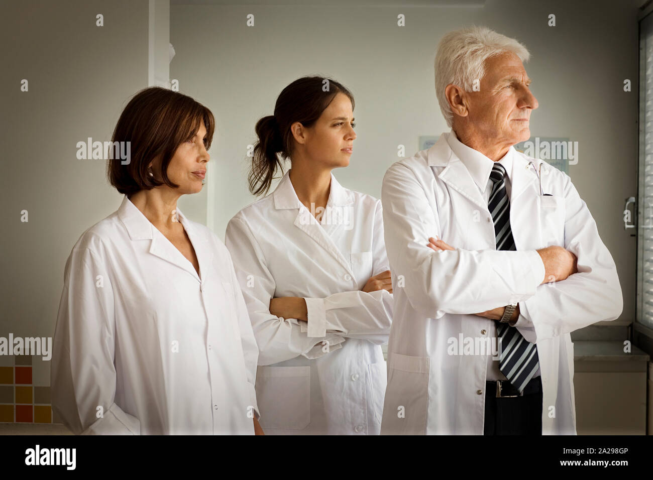View of three doctors staring outside Stock Photo - Alamy