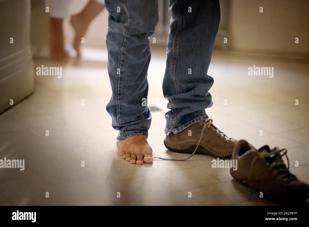 View of a man wearing his shoes Stock Photo - Alamy