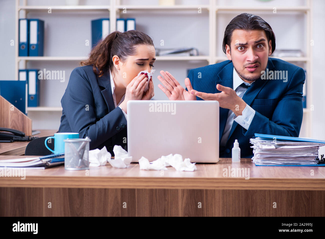 The two employees suffering at workplace Stock Photo - Alamy
