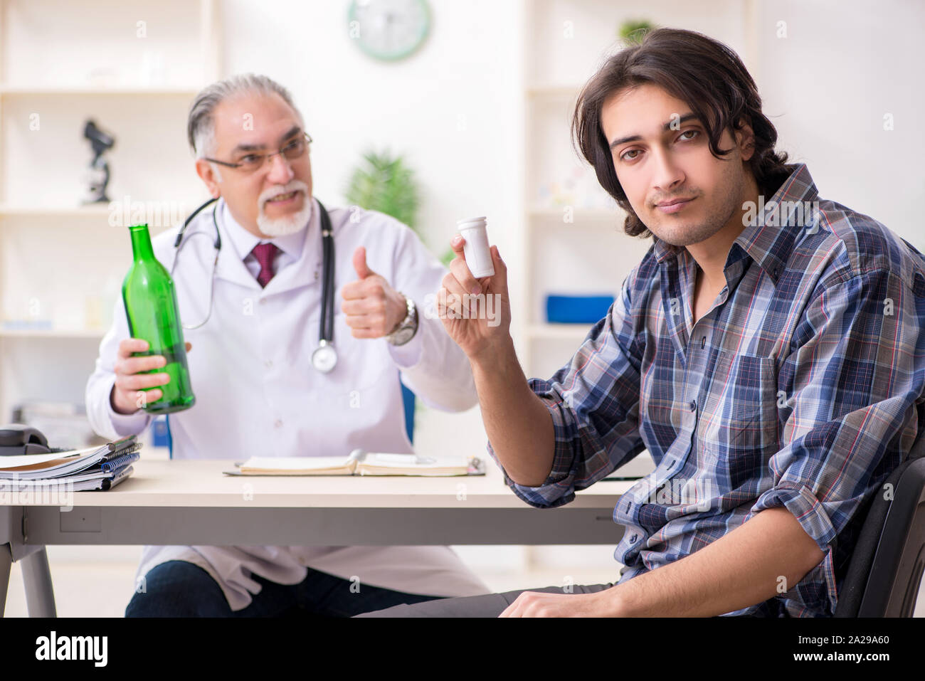 The young male alcoholic visiting old doctor Stock Photo - Alamy