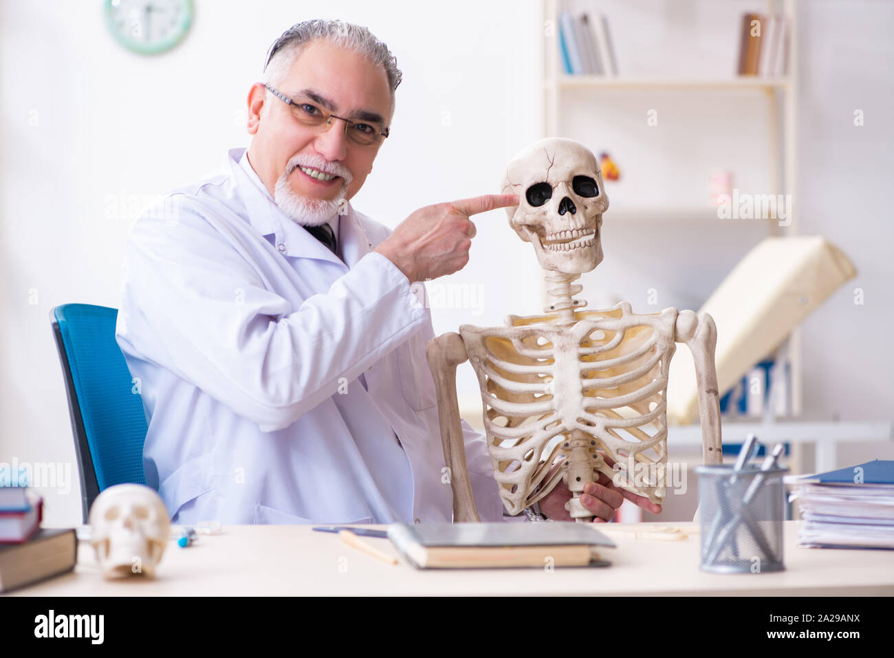 Aged male doctor with skeleton hi-res stock photography and images - Alamy