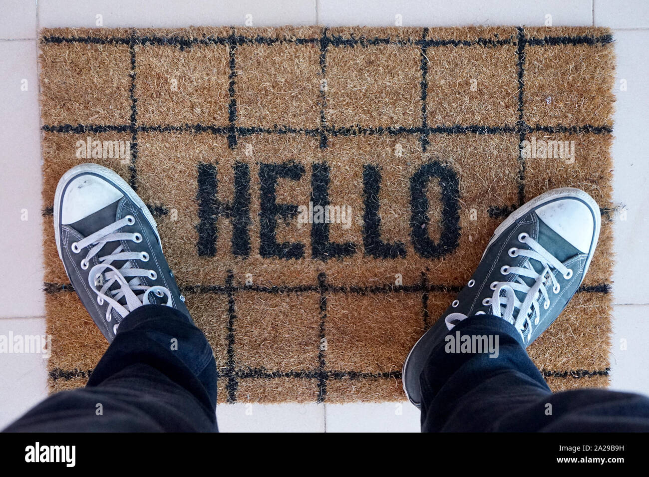 Door mat hello! Stock Photo - Alamy
