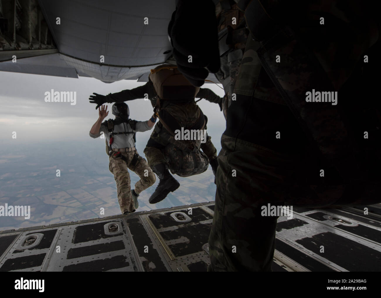 A U.S. military jumpmaster jumps with a student from the Bulgarian 68th ...