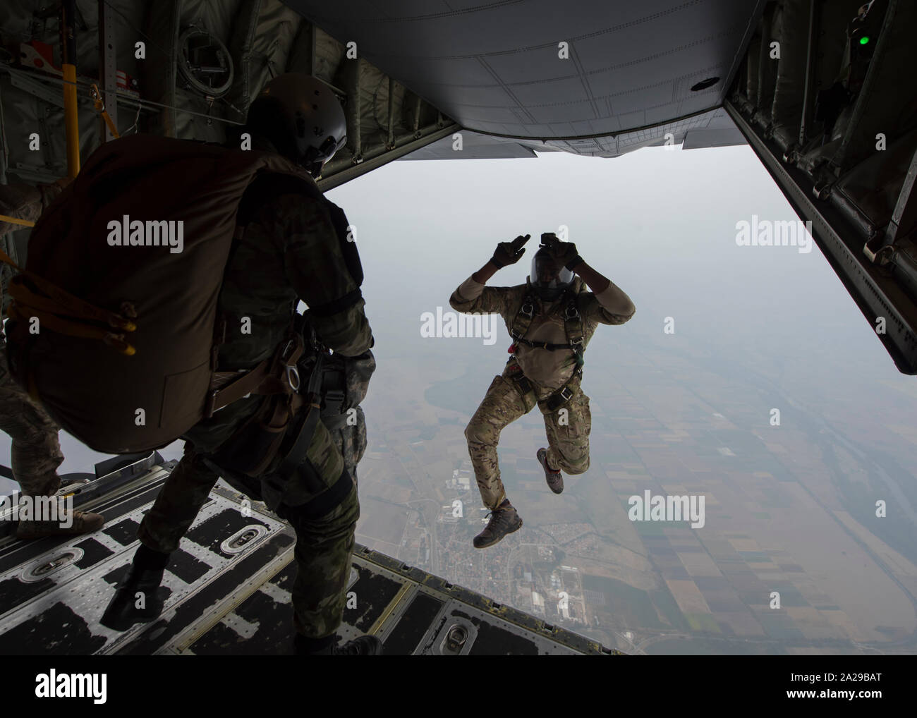 A U.S. military jumpmaster models an aircraft exit for a student from ...