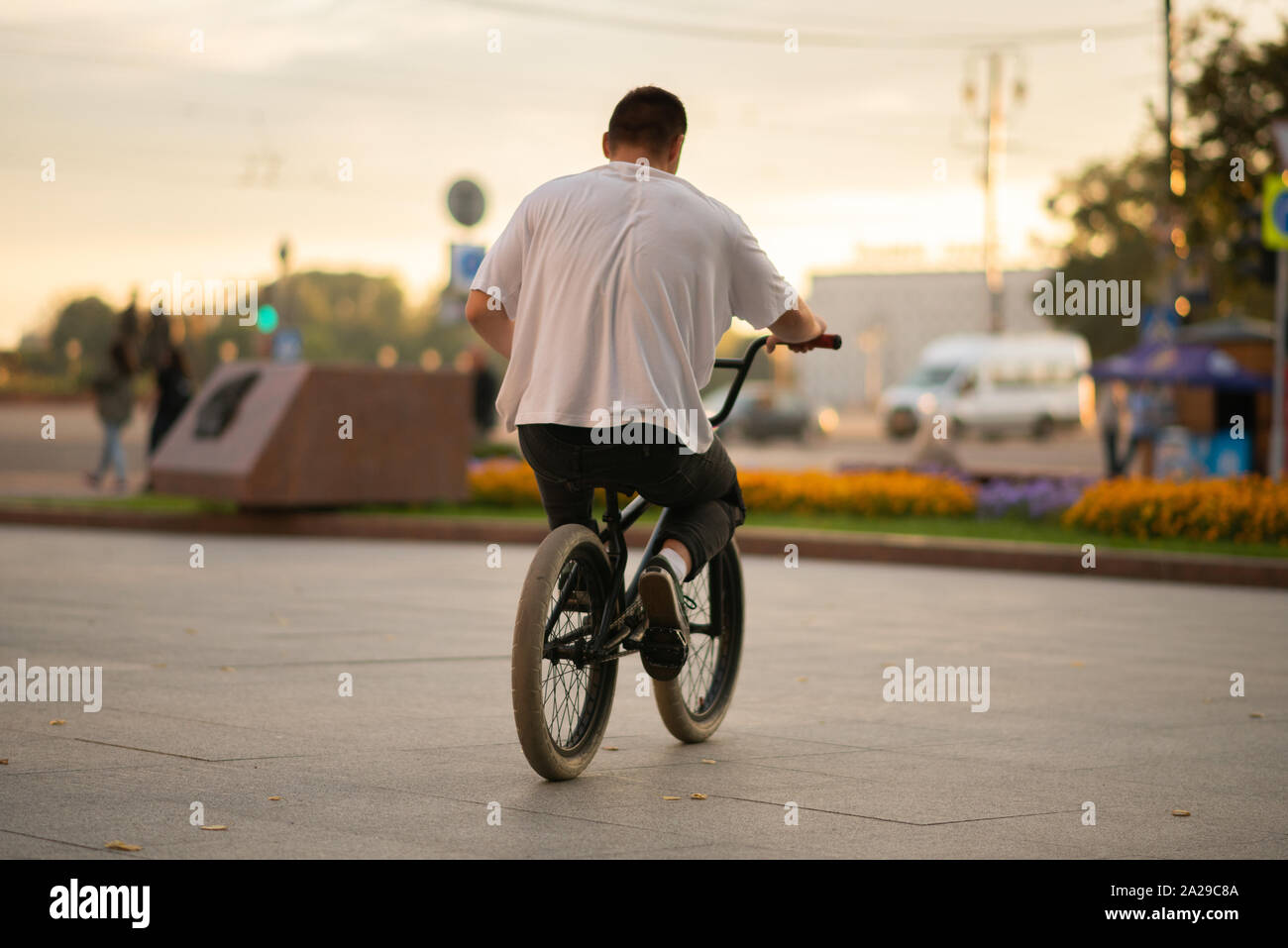 The guy rides on the BMX, sitting on the seat Stock Photo - Alamy