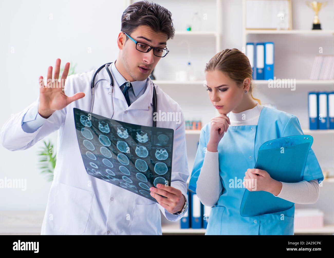 The two doctors examining x-ray images of patient for diagnosis Stock ...