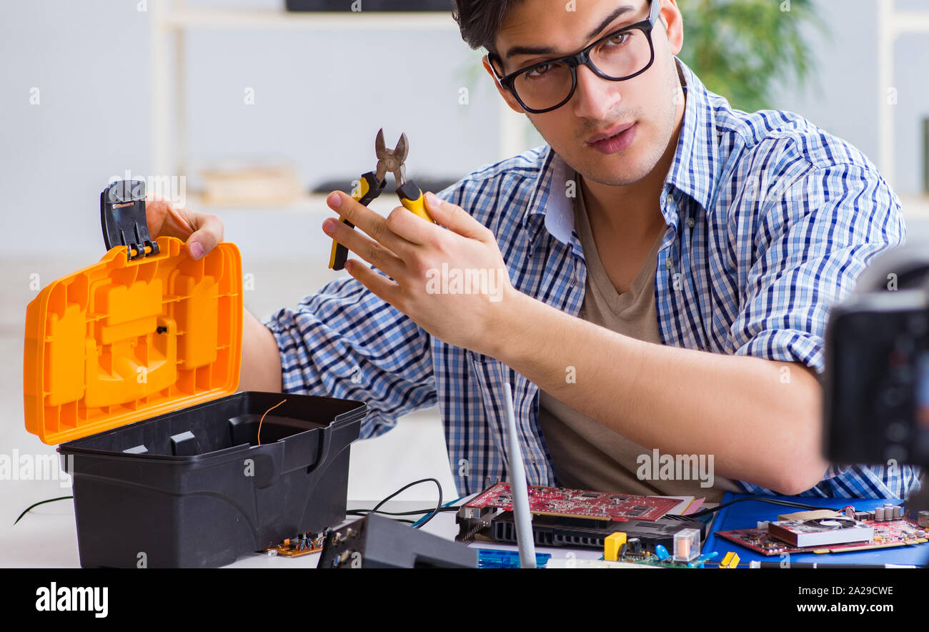 The vlogger recording computer repair on camera for vlog blog Stock ...