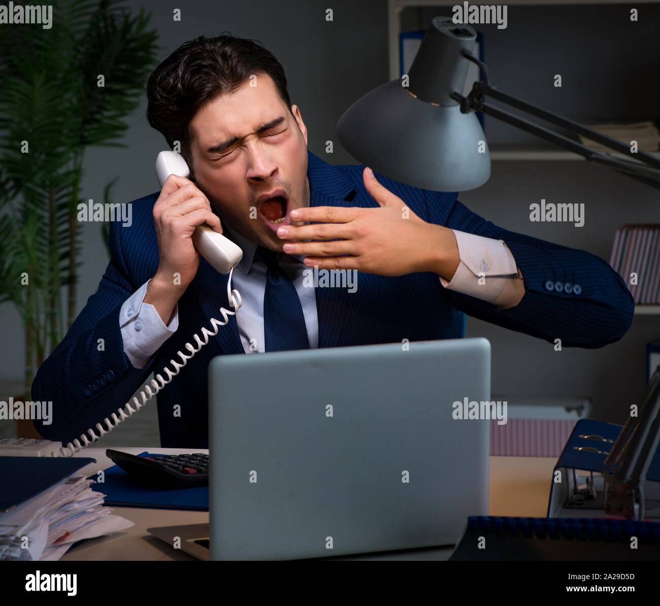 Employee working late to finish important deliverable task Stock Photo ...