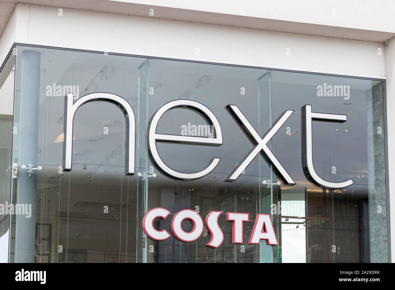 The exterior showing the sign or logo of a Next store and Costa coffee ...