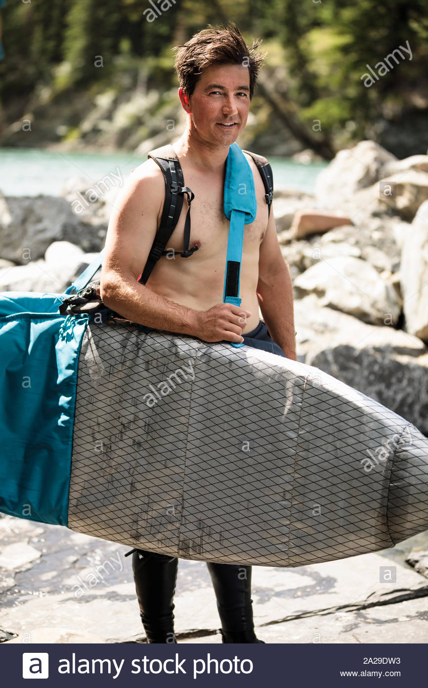 Man carrying surfboard hi-res stock photography and images - Alamy
