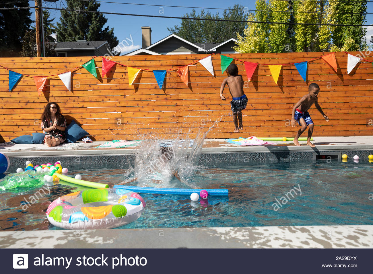 Family jumping into pool hi-res stock photography and images - Alamy