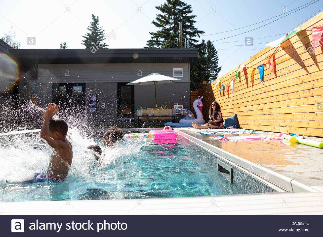 Mother daughter jumping swimming pool hi-res stock photography and ...