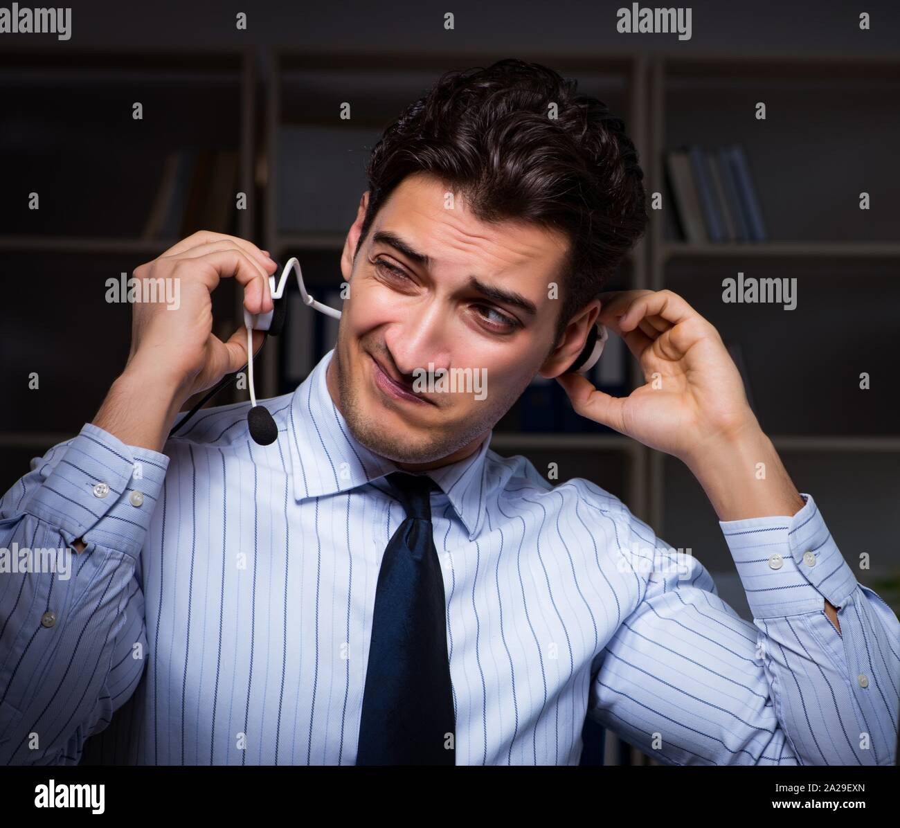 The tired and exhausted helpdesk operator during night shift Stock ...