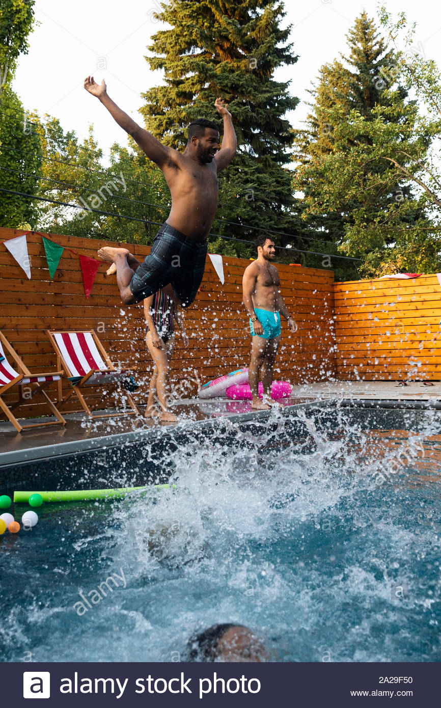 Man jumping into swimming pool hi-res stock photography and images - Alamy
