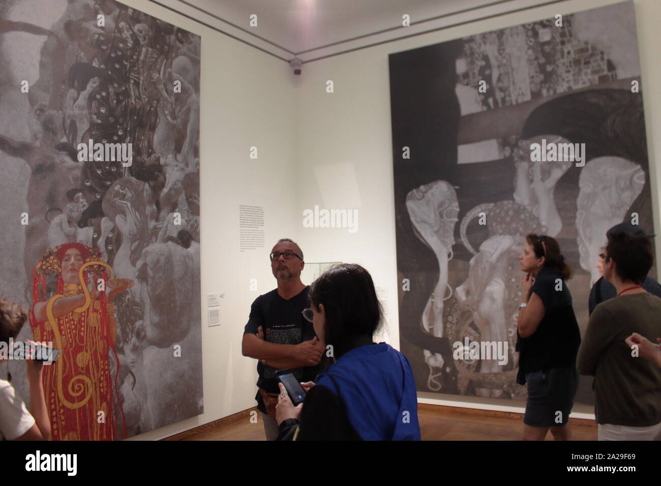 At the leopold museum, tourists admire a reproduction of the panels ...