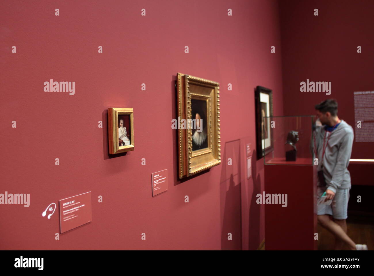 A tourist is looking at three paintings from a Young Gustav Klimt in a ...