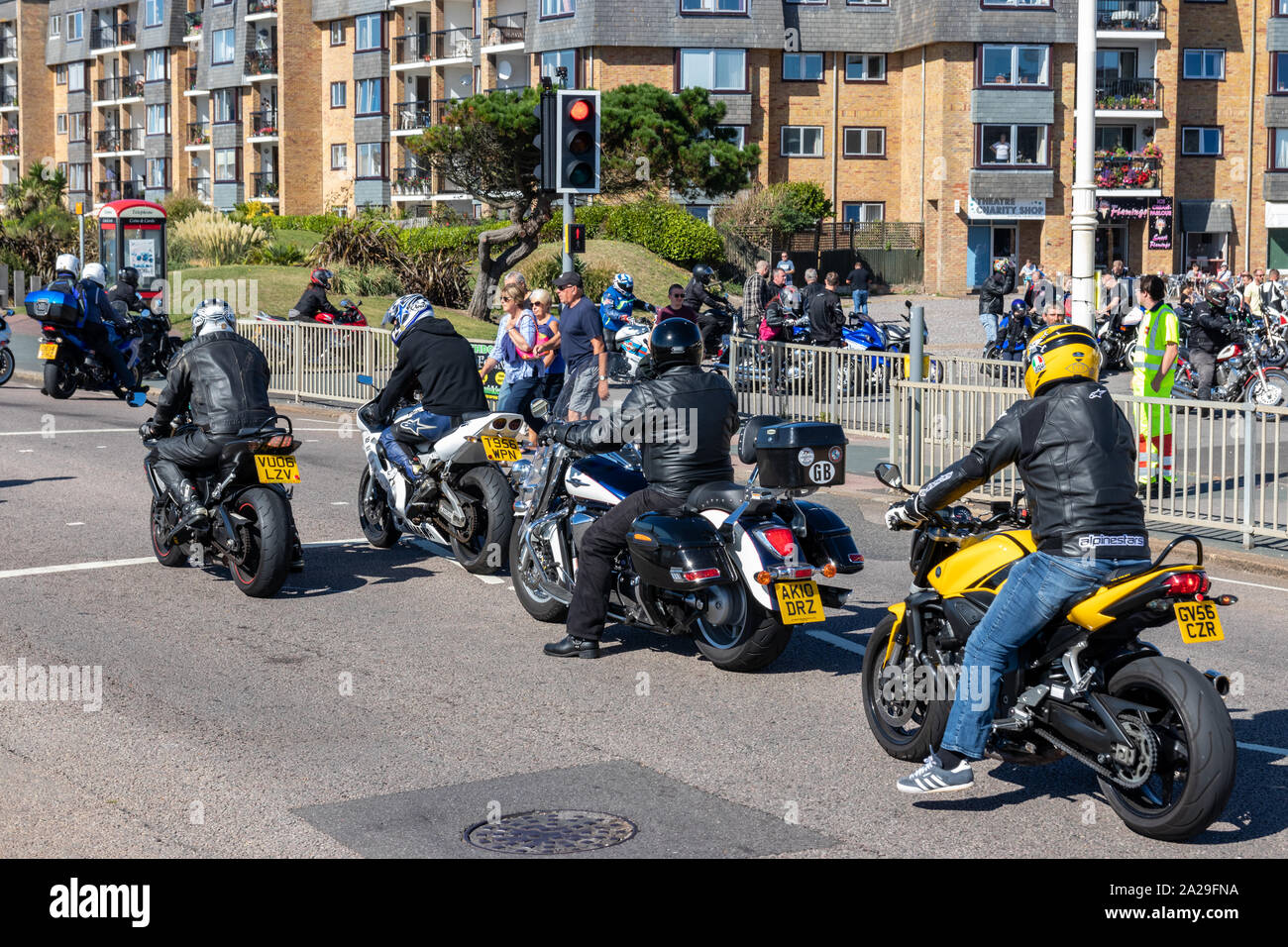 A group of motorcyclists on the road on their motorbikes wearing ...