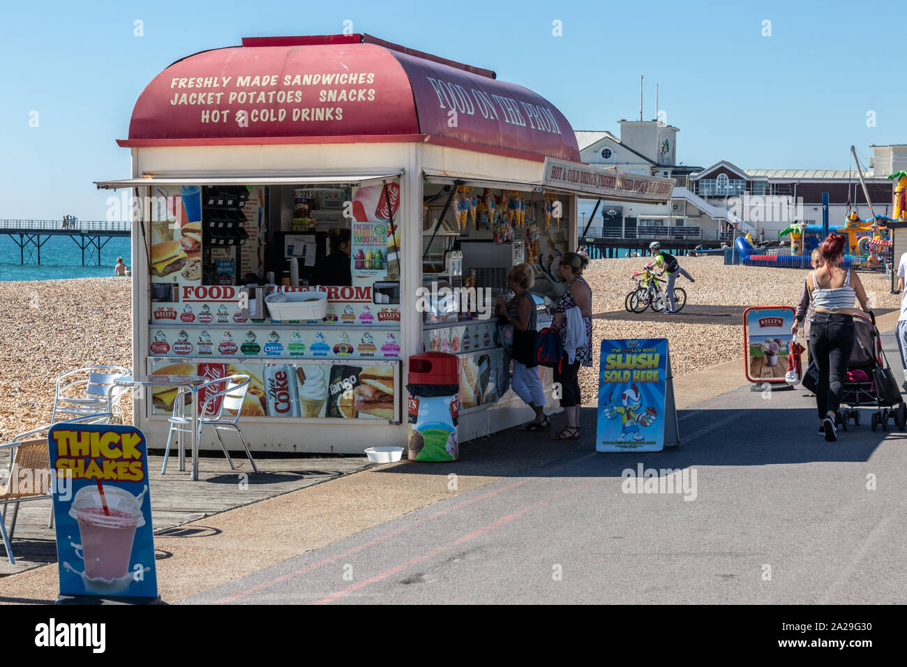 A seaside food kiosk on a British beach selling ice cream, sticks of ...