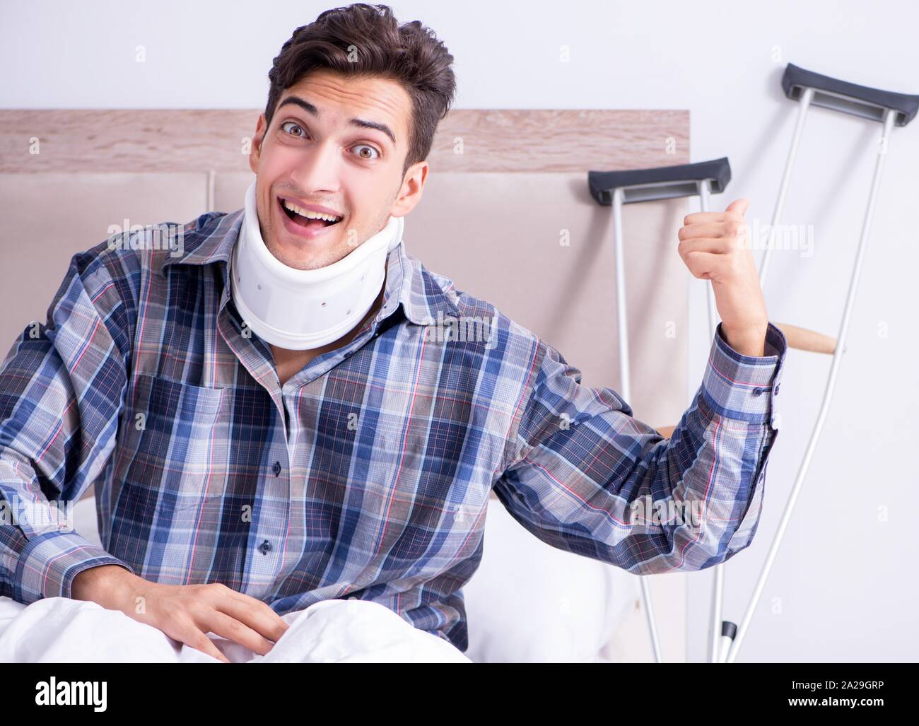 Injured man in bed at home with crutches hi-res stock photography and ...