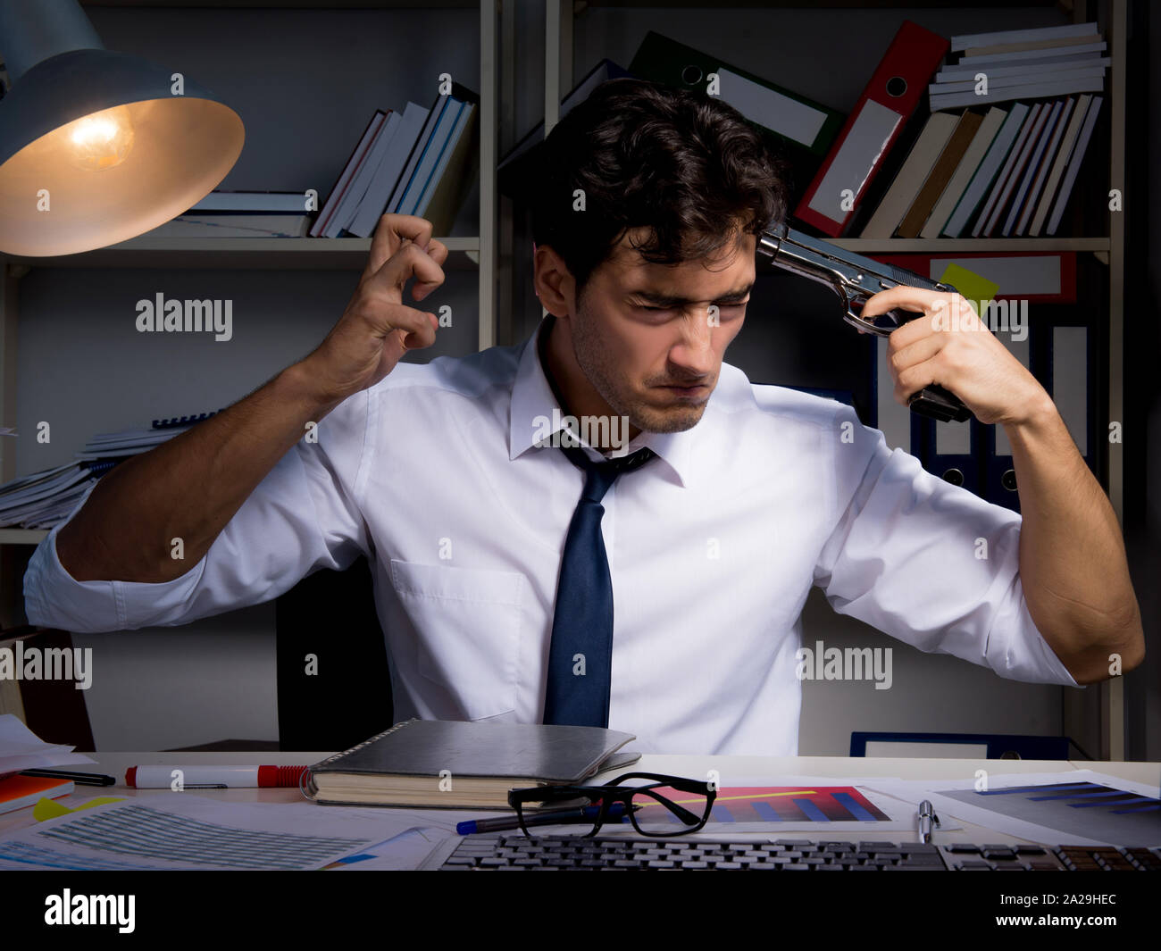 The man businessman working late hours in the office Stock Photo - Alamy