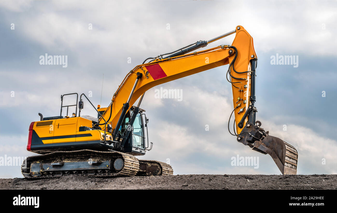Big excavator in construction site Stock Photo - Alamy