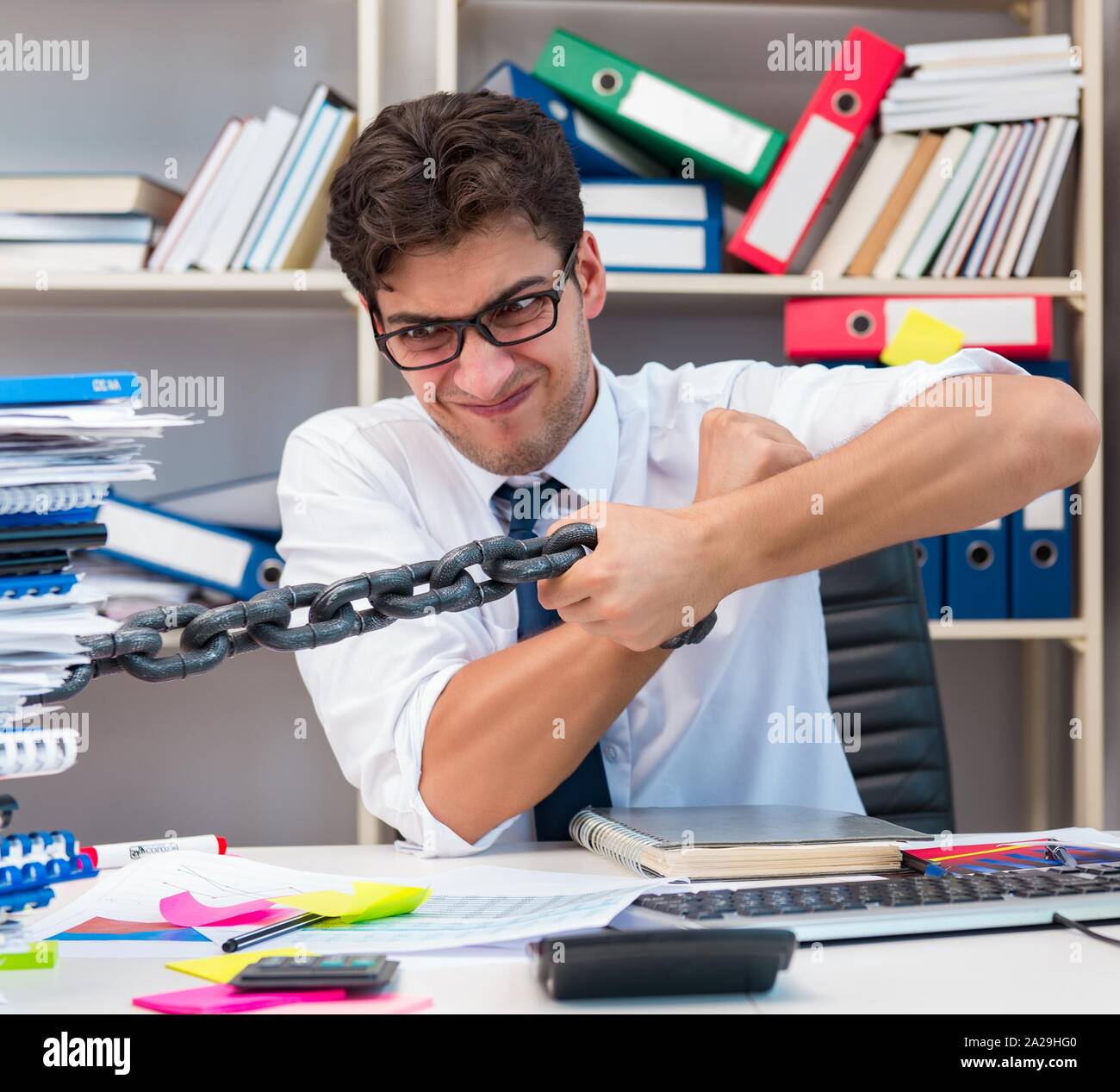 The employee attached and chained to his desk with chain Stock Photo ...