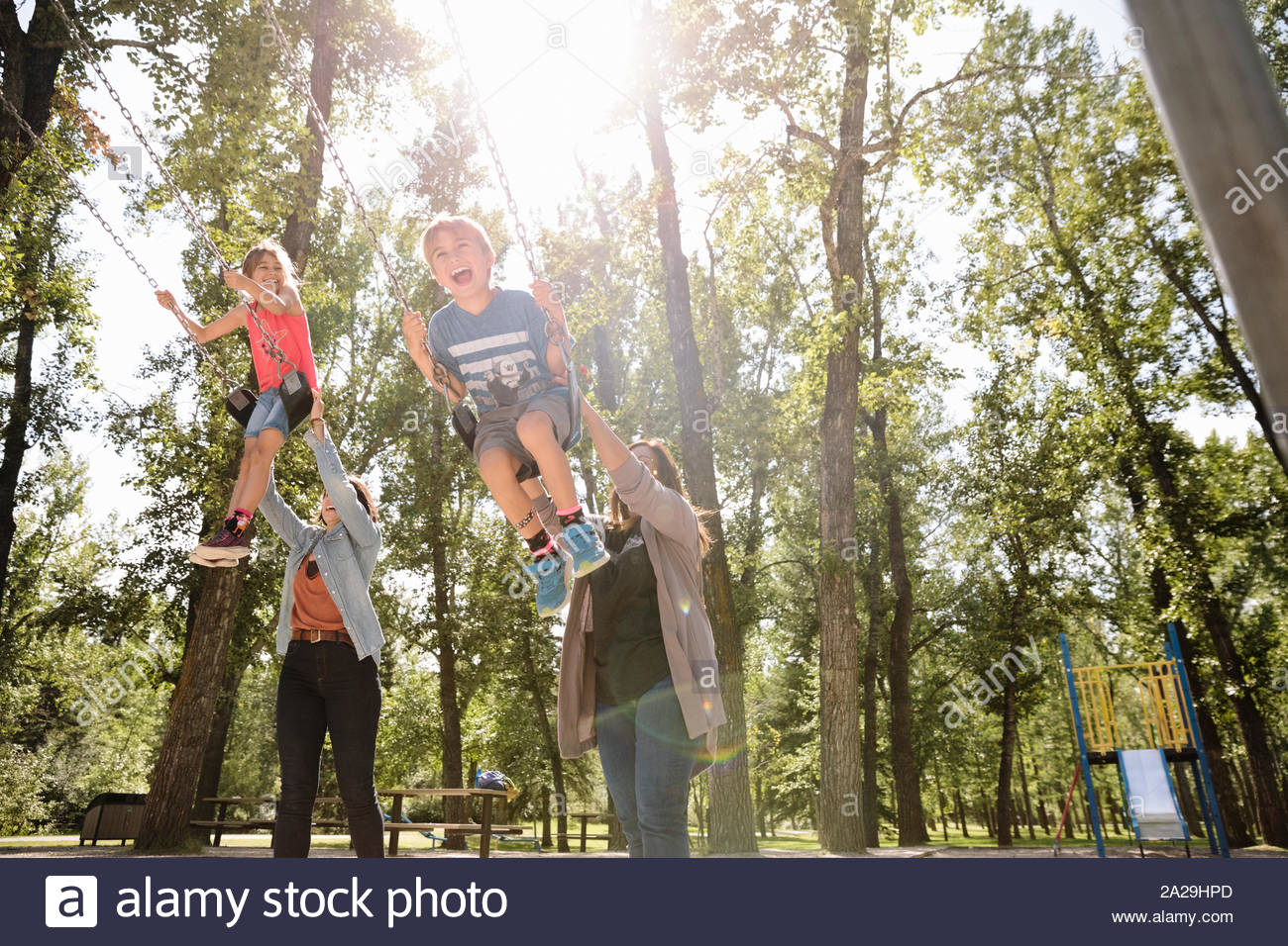 Children pushed on swings hi-res stock photography and images - Alamy