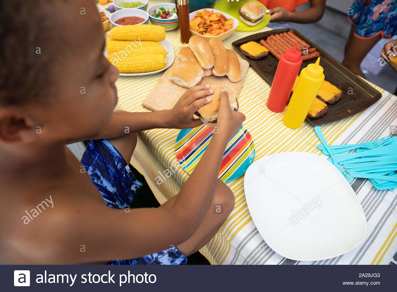 African boy eating hamburger hi-res stock photography and images - Alamy